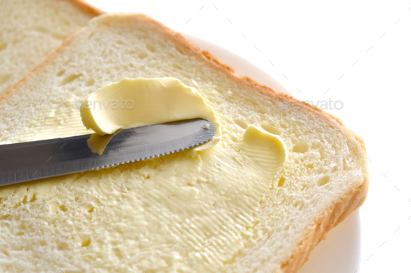 A knife spreading butter on bread. Stock Photo by Maliflower73 | PhotoDune